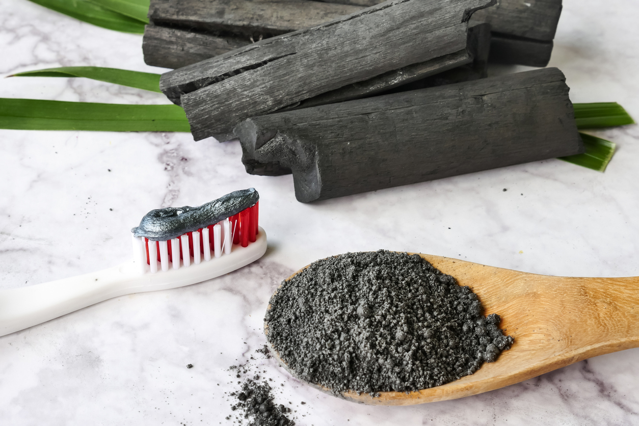 Toothpaste by activated charcoal powder on marble table - DP General ...